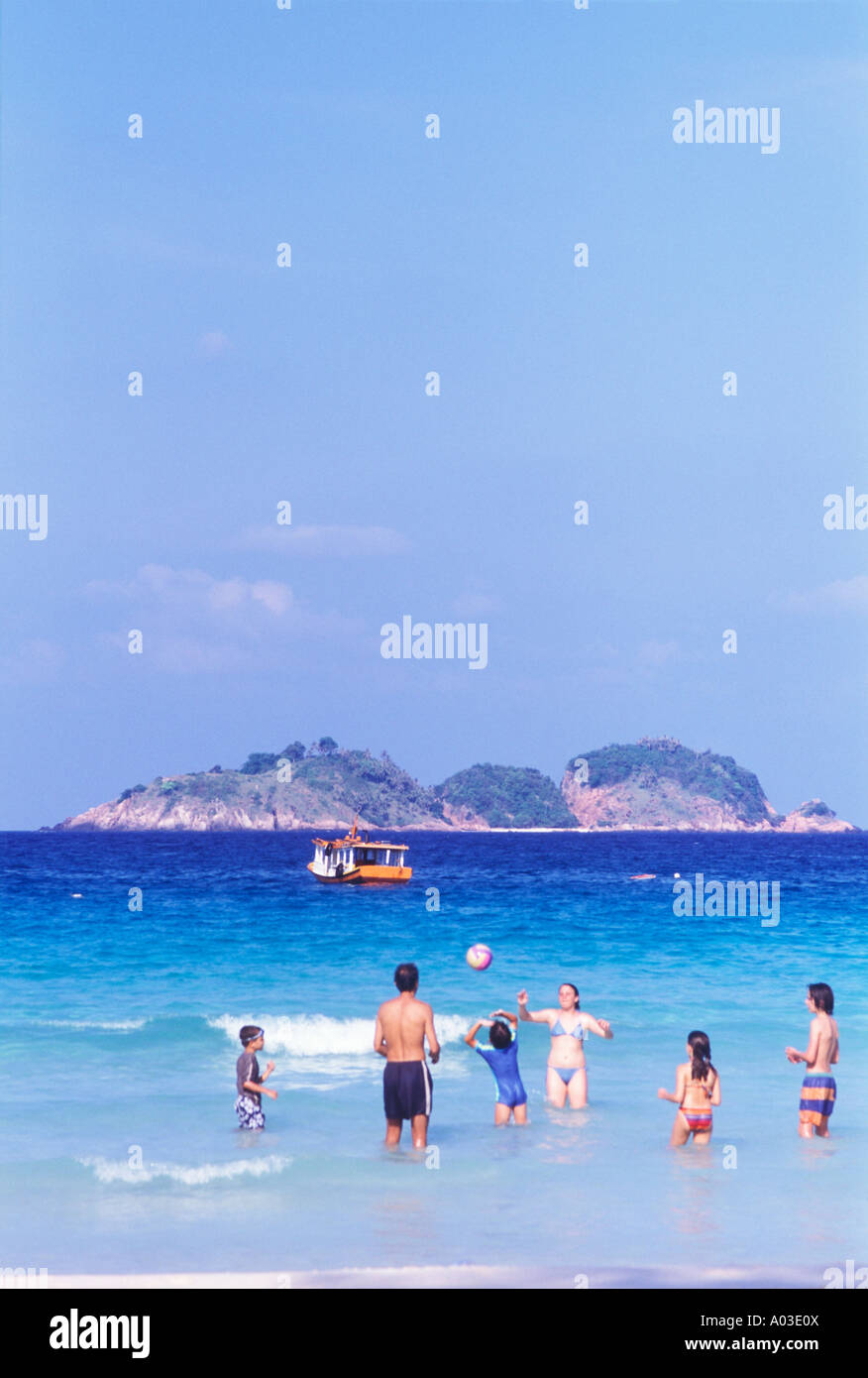 Family playing at holiday seaside resort Stock Photo - Alamy