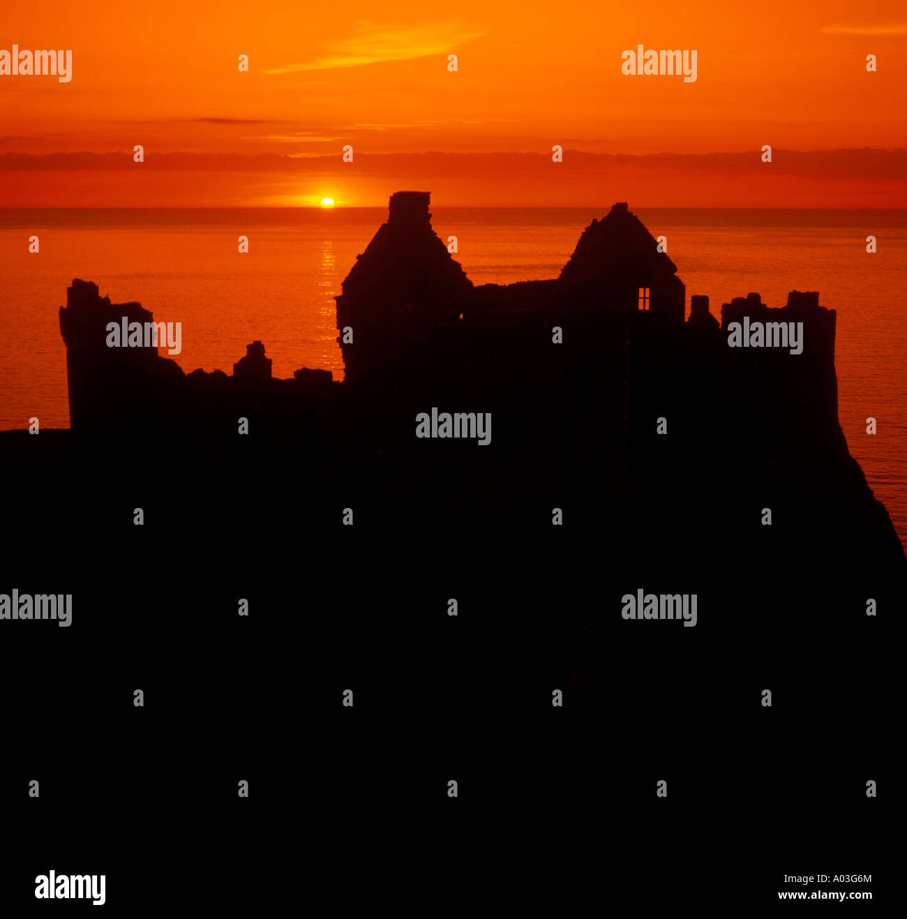 silhouette of Dunluce Castle in County Antrim in Northern Ireland at ...