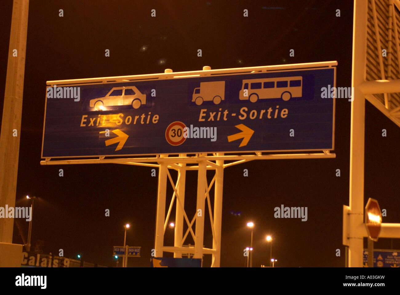 Calais ferry port signs at night giving drivers of cars, lorries and ...