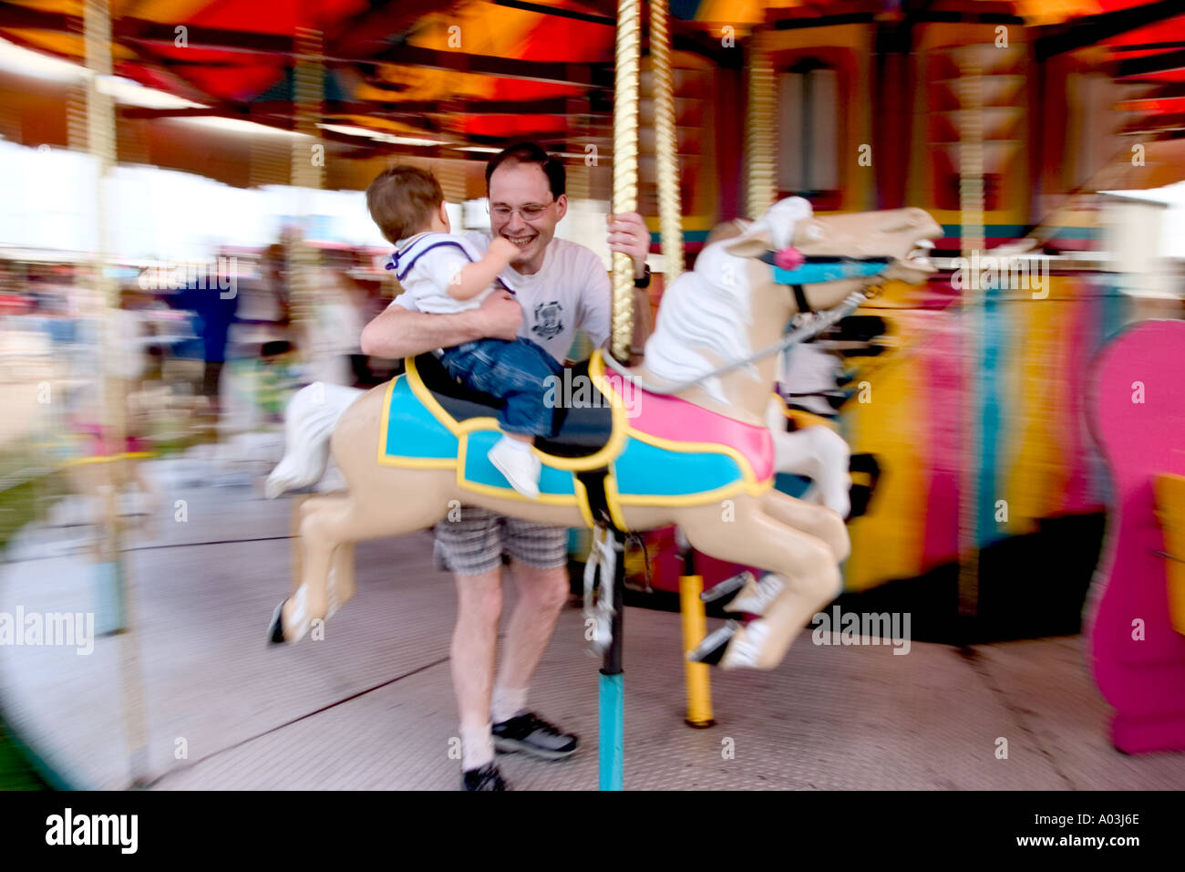 Riding a merry go round hi-res stock photography and images - Alamy