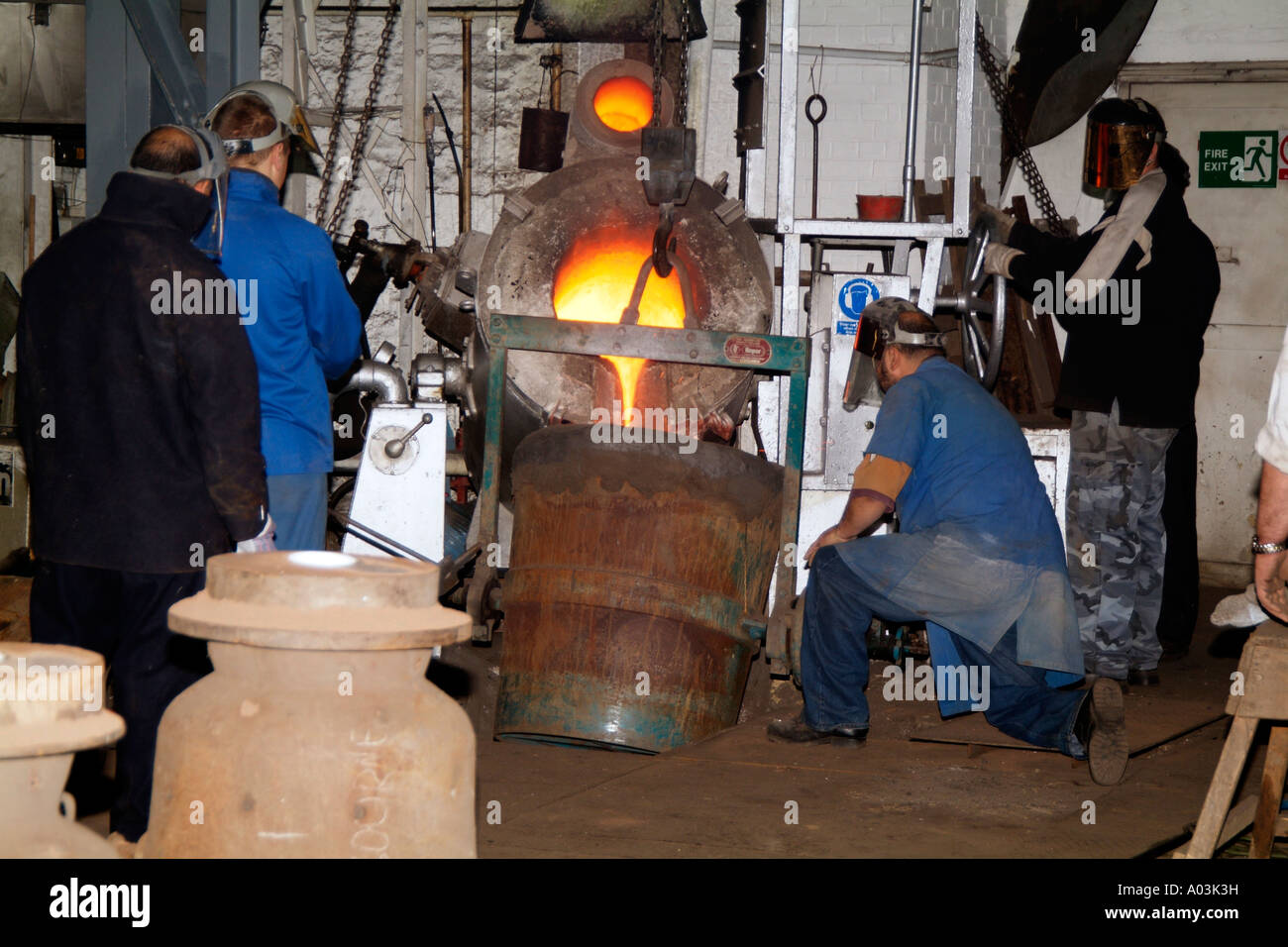 Bell manufacturing. Pouring molten metal from the furnace. Whitechapel ...