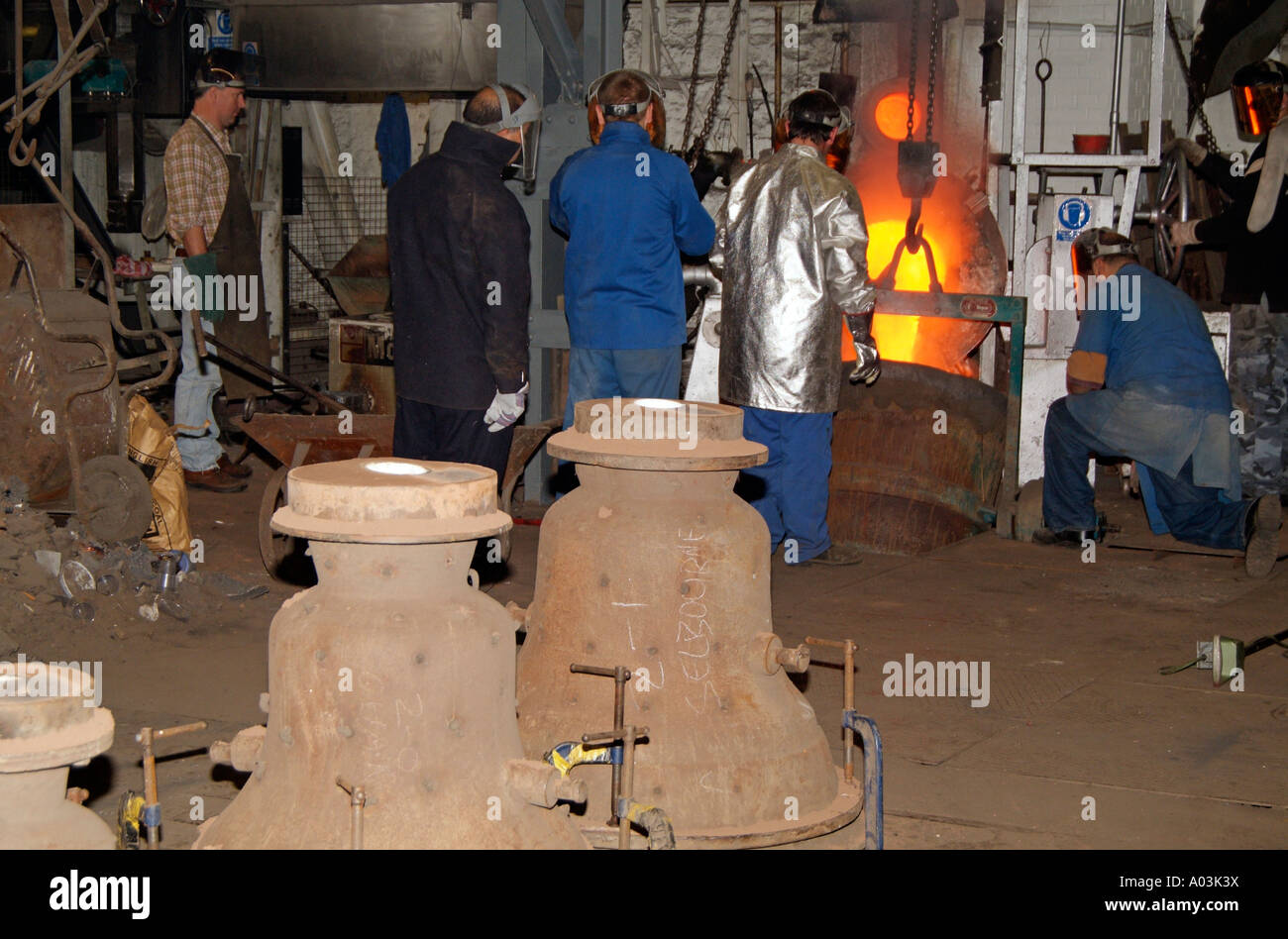 Bell manufacturing. Pouring molten metal from the furnace. Whitechapel ...