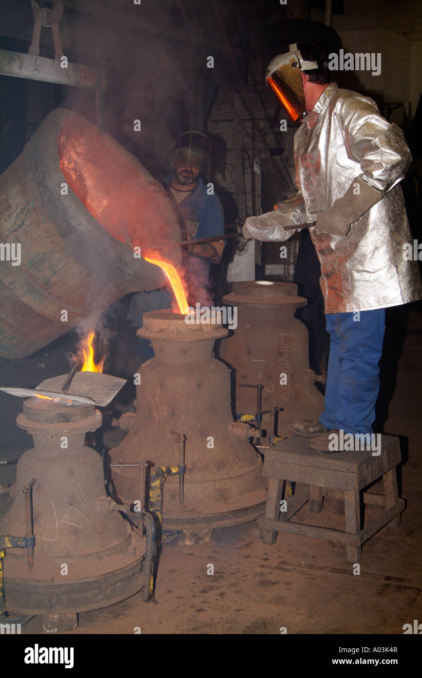 Casting a church bell.Molten metal pouring into a bell mould at ...