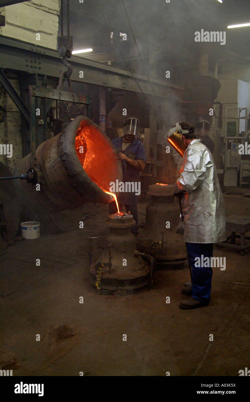 Casting a church bell.Molten metal pouring into a bell mould at ...