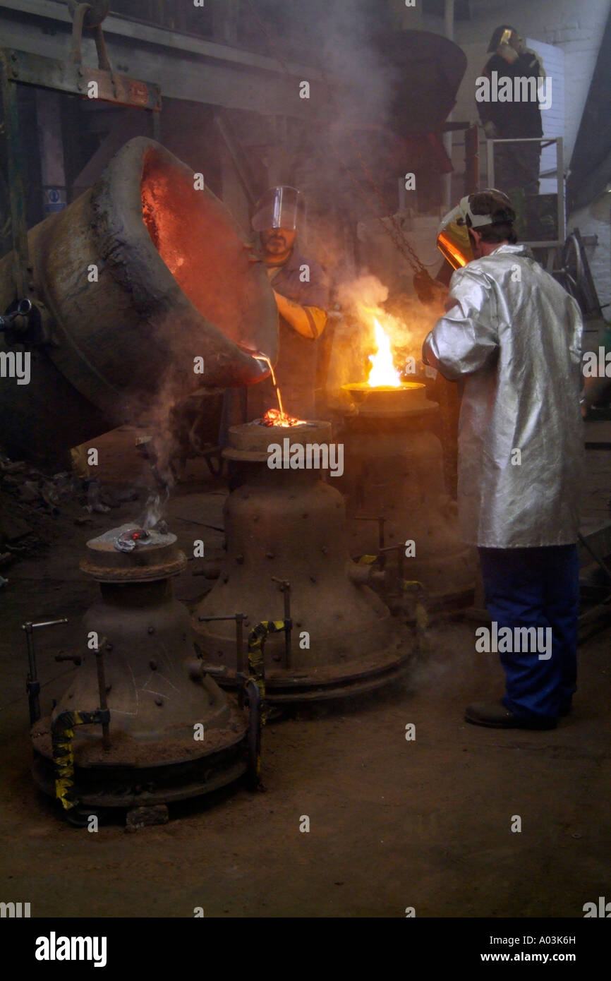 Casting a church bell.Molten metal pouring into a bell mould at ...