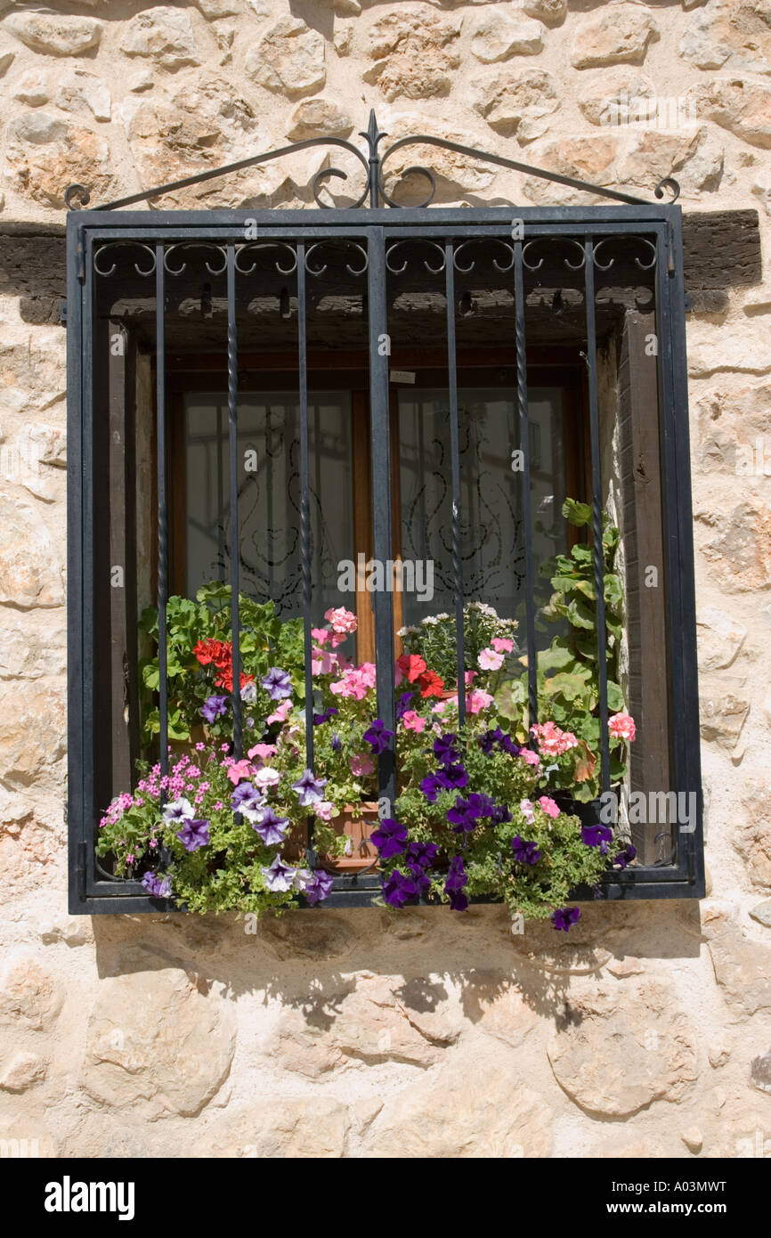 Old window with flowers and wrought iron grill Covarrubias Old Castille ...