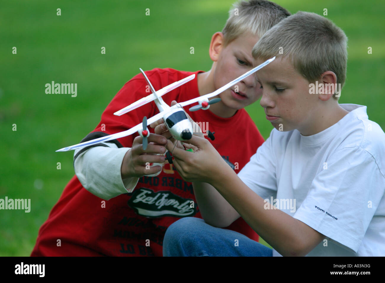two boys with a remote controlled plane Stock Photo - Alamy