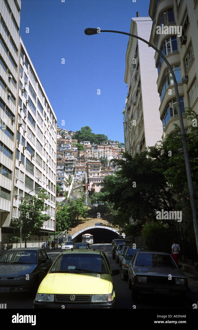 Portrait view of an entrance to a road tunnel with a favela above it ...