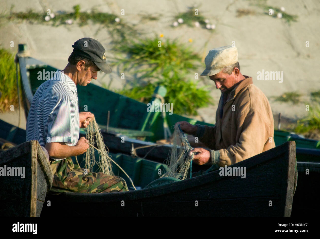 Men working on fishing net, Danube Delta, Romania Stock Photo - Alamy