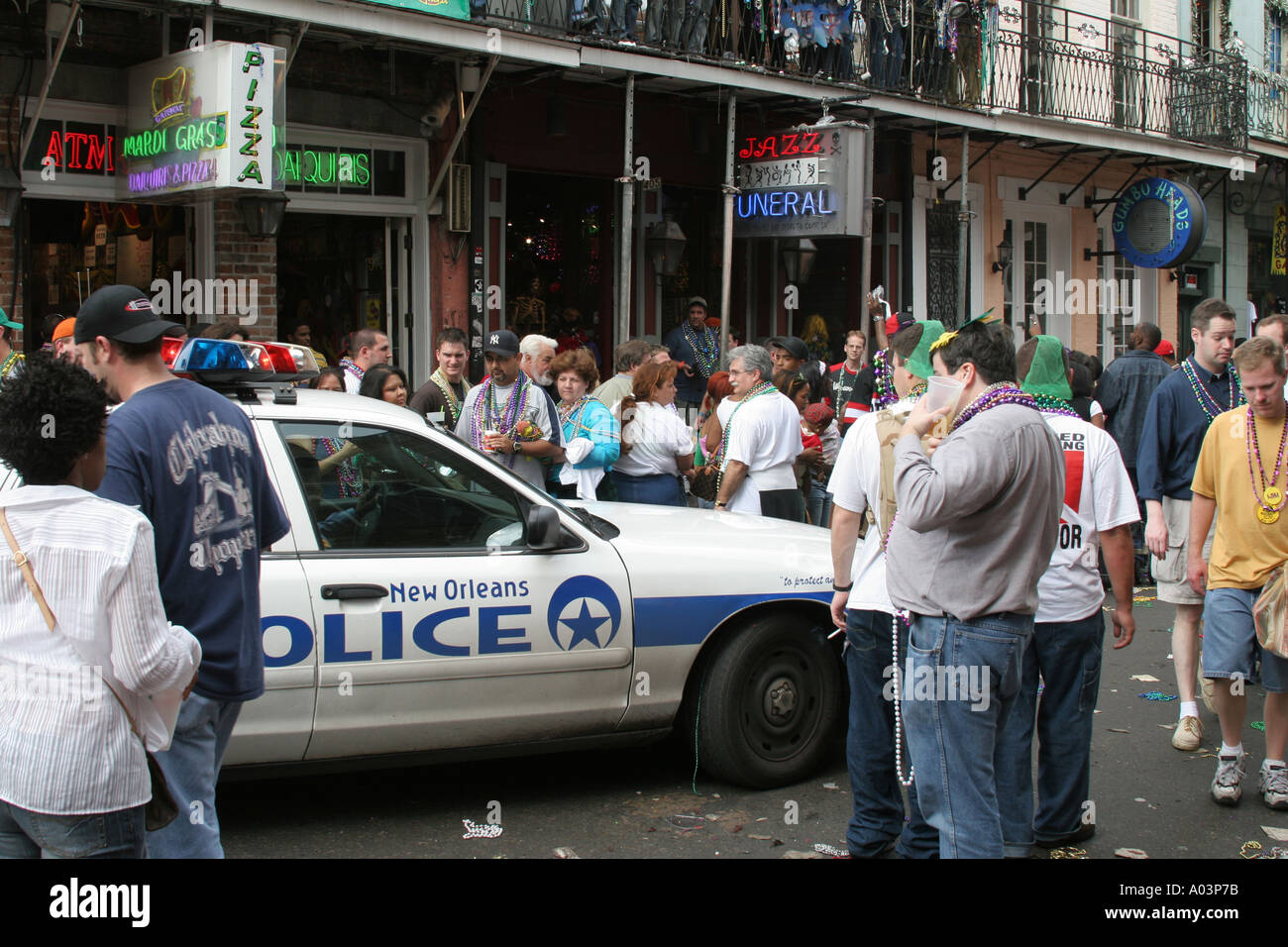A police car makes its way through the crowd at Mardi Gras Stock Photo ...