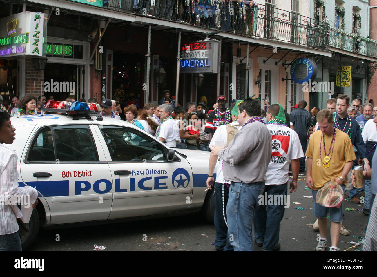 A police car makes its way through the crowd at Mardi Gras Stock Photo ...