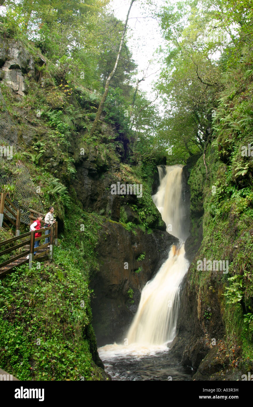 two boys looking at Ess-na-Larach Waterfall in the Glens of Antrim in ...