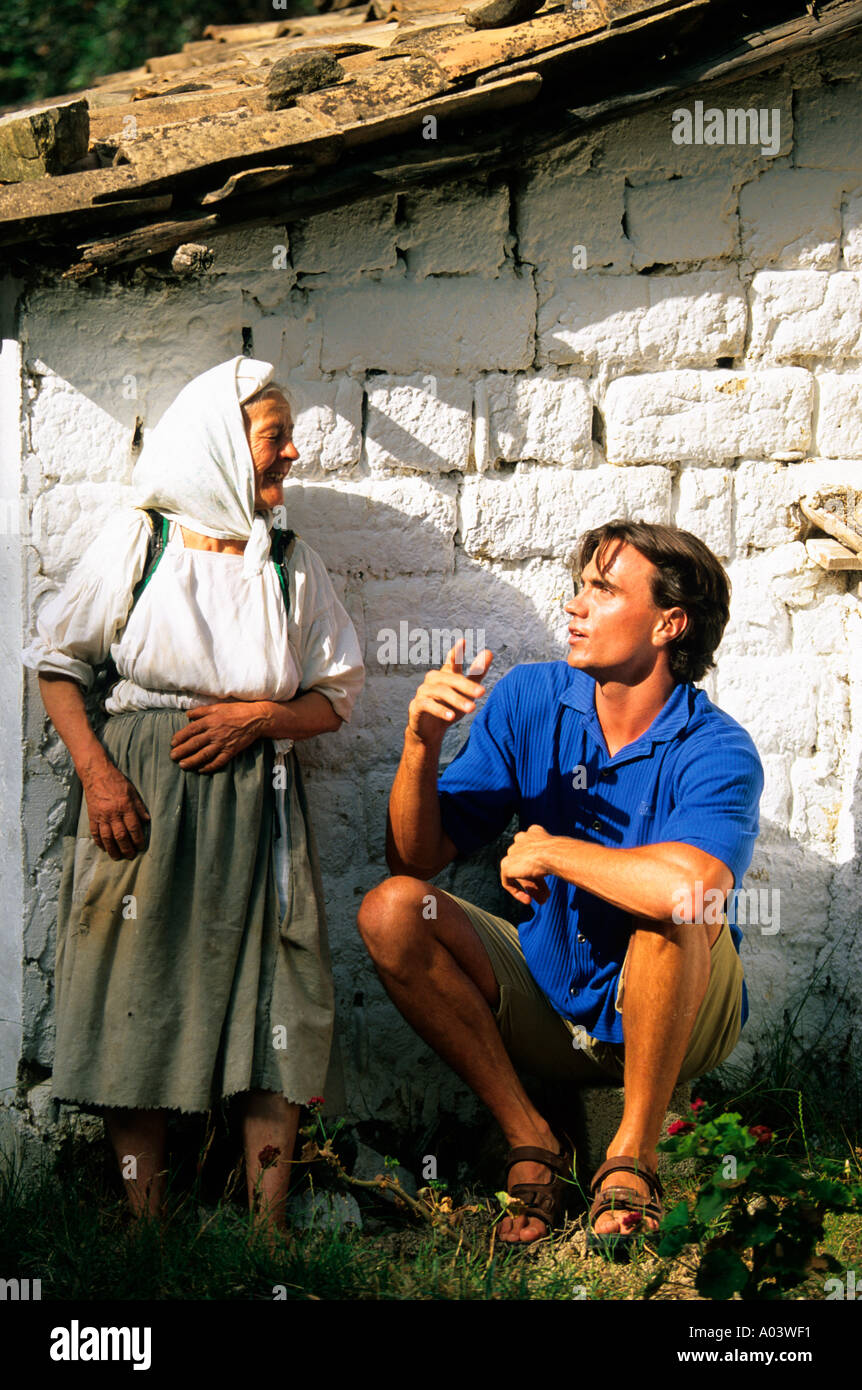 greece ionian corfu a tourist talking to a traditionally dressed local ...