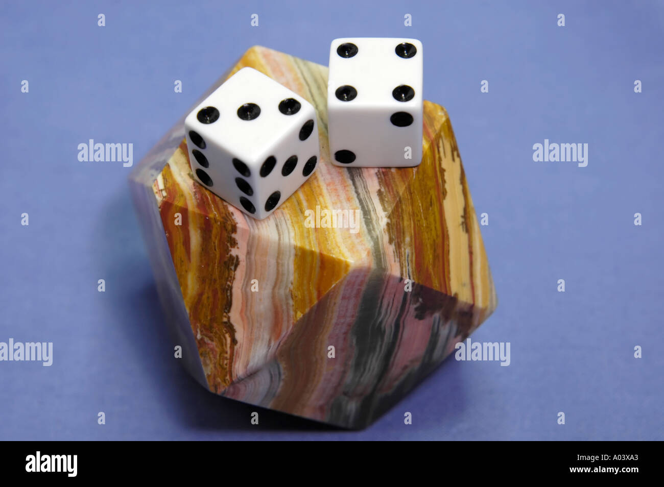 Pair of dice showing the number 7 seven sitting on top of colorful ...