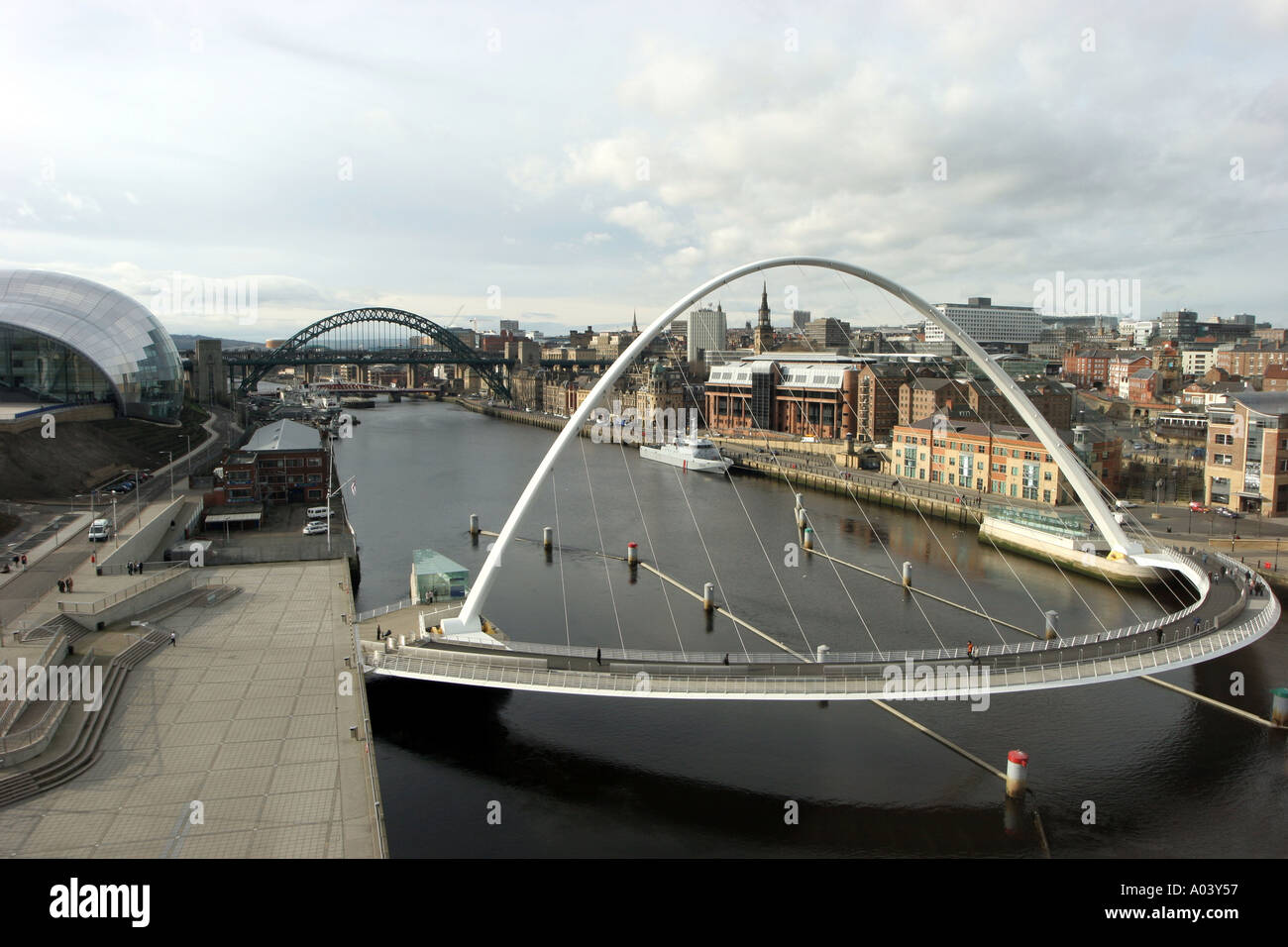 The Millennium Eye bridge over the River Tyne with the Tyne bridge in ...