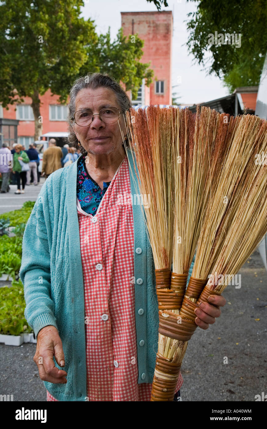 Italian woman holding hand made straw broom for sale at the weekly ...
