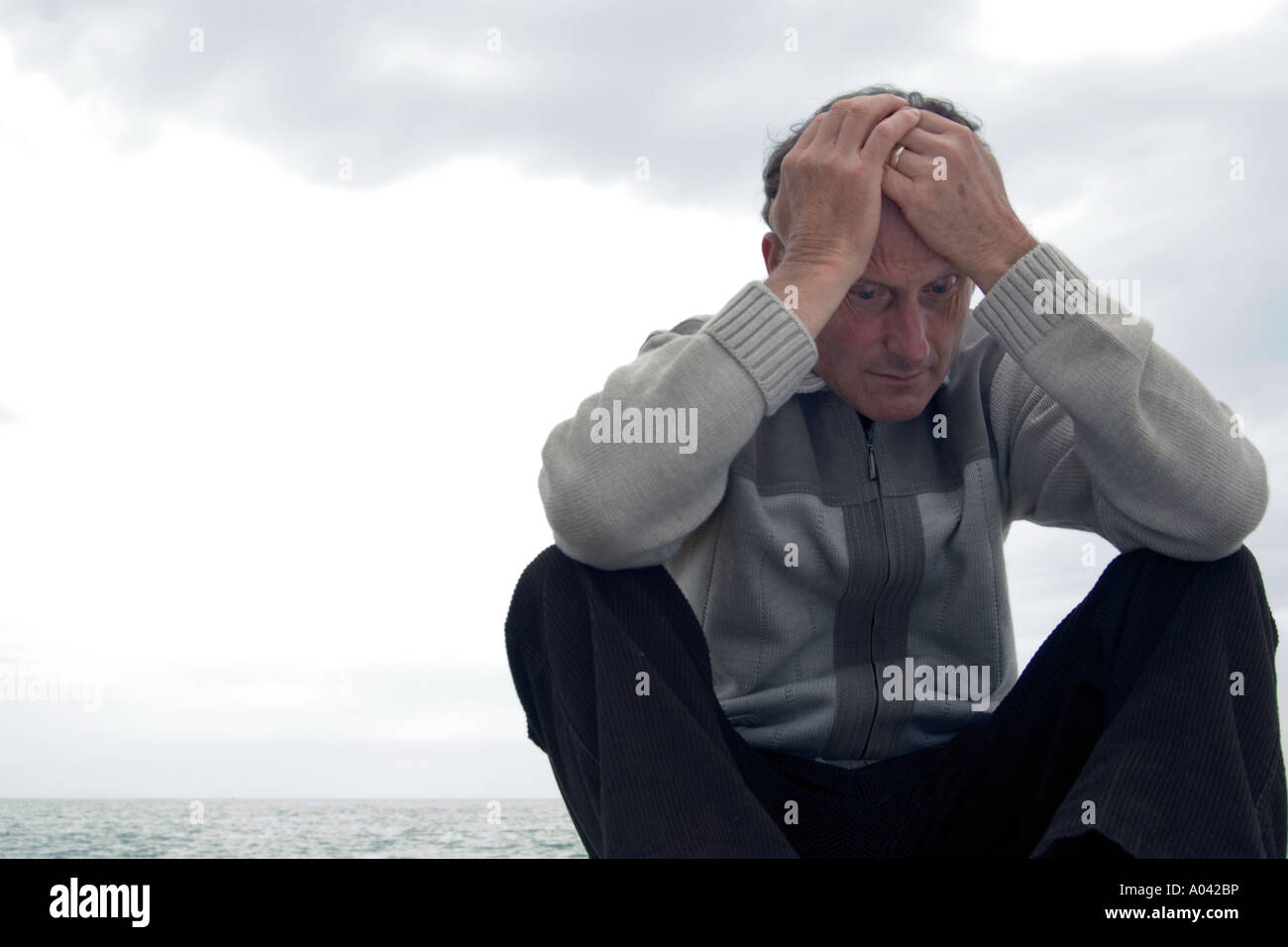 mature man with his head in his hands Stock Photo - Alamy