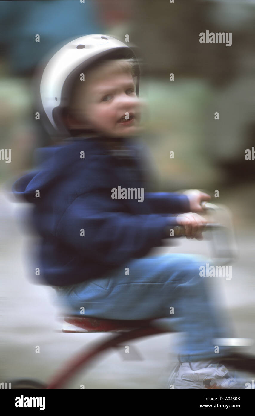 Young Boy Riding Tricycle Stock Photo - Alamy