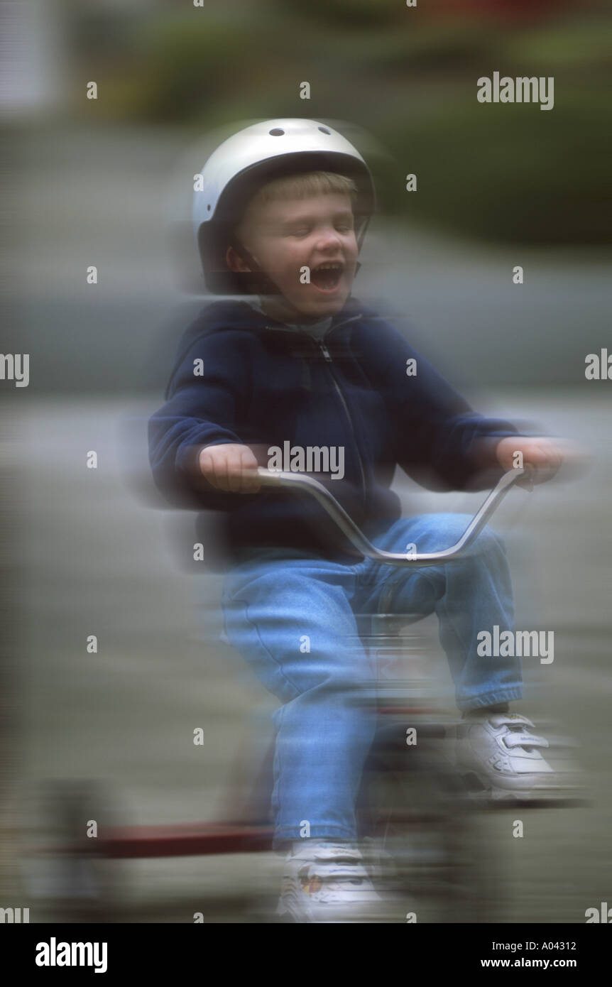 Young Boy Riding Tricycle Stock Photo - Alamy