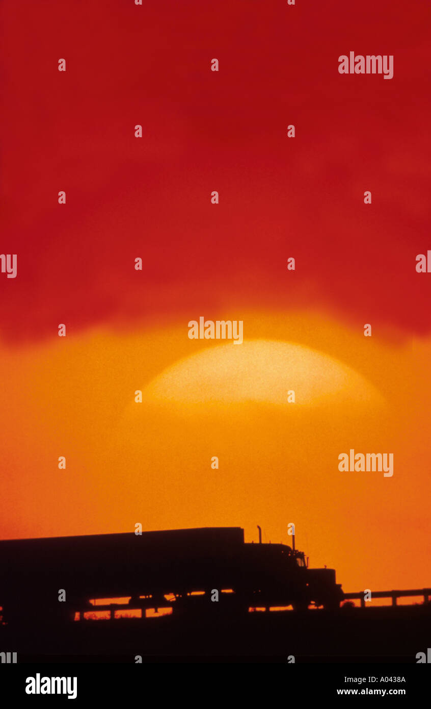 Truck on highway Giant Sun Stock Photo - Alamy