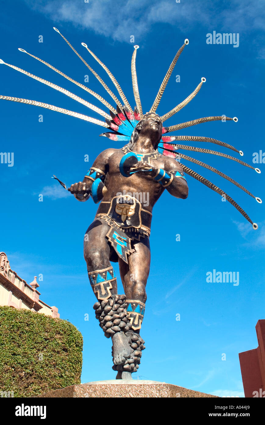 Statue of plumed Indian dancer outside Templo de San Francisco ...