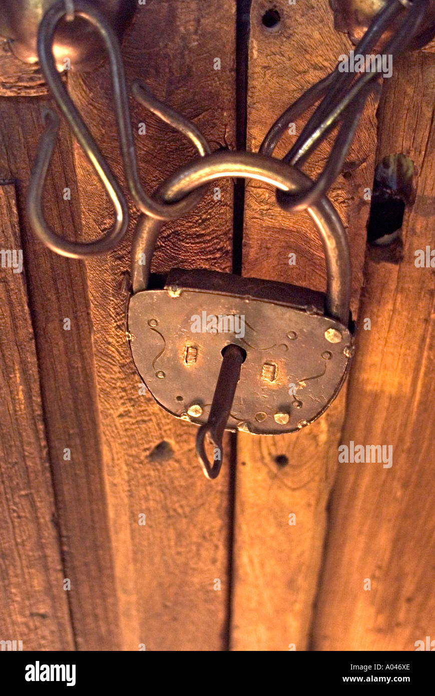 Old fashioned rustic padlock with key Stock Photo - Alamy