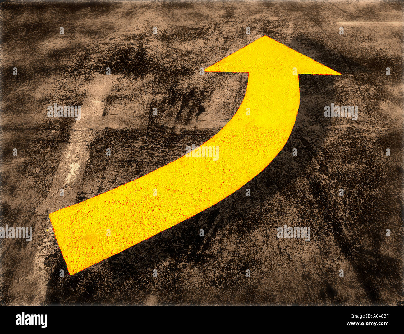 Big yellow arrow on road Stock Photo - Alamy