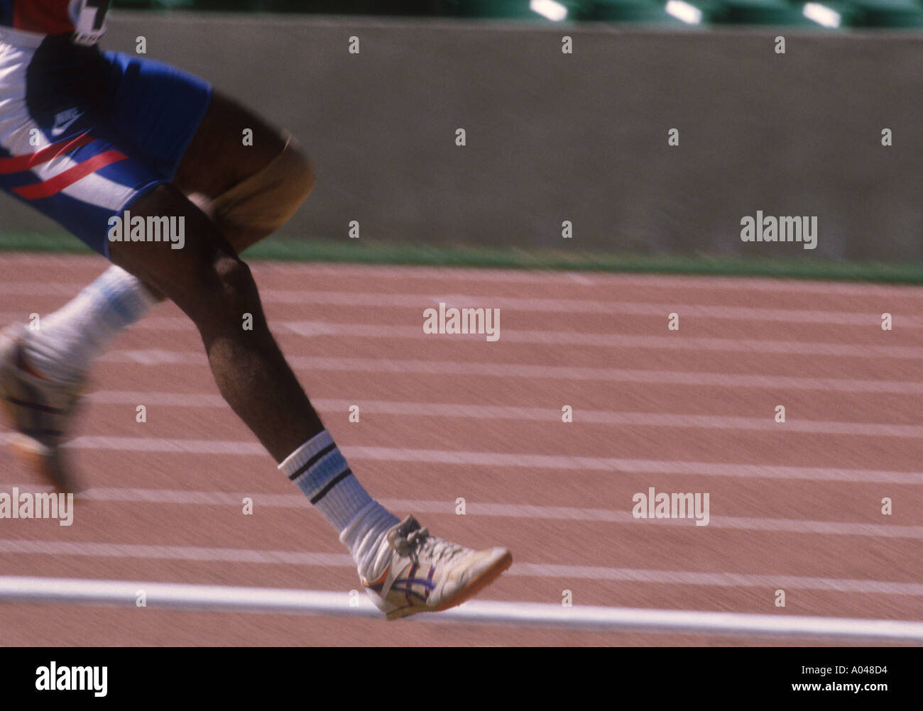 Athletic legs on track Stock Photo - Alamy