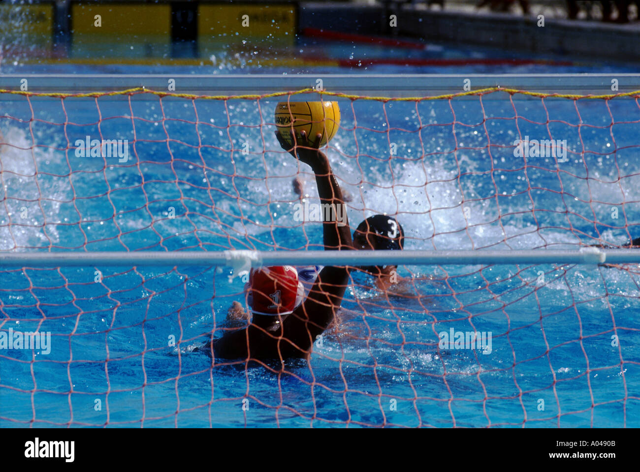 Water polo goalie holds ball Stock Photo - Alamy
