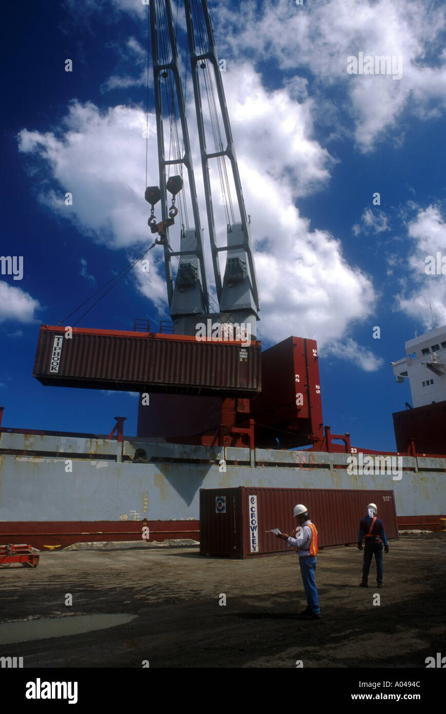 Crane lifting cargo container from ship Stock Photo - Alamy
