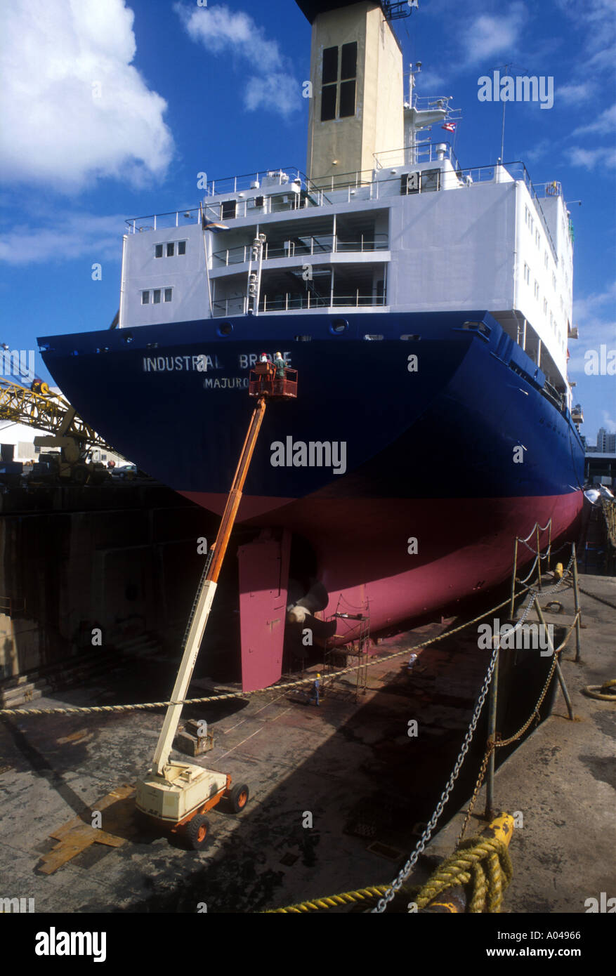 Workers painting ship in drydock Stock Photo - Alamy