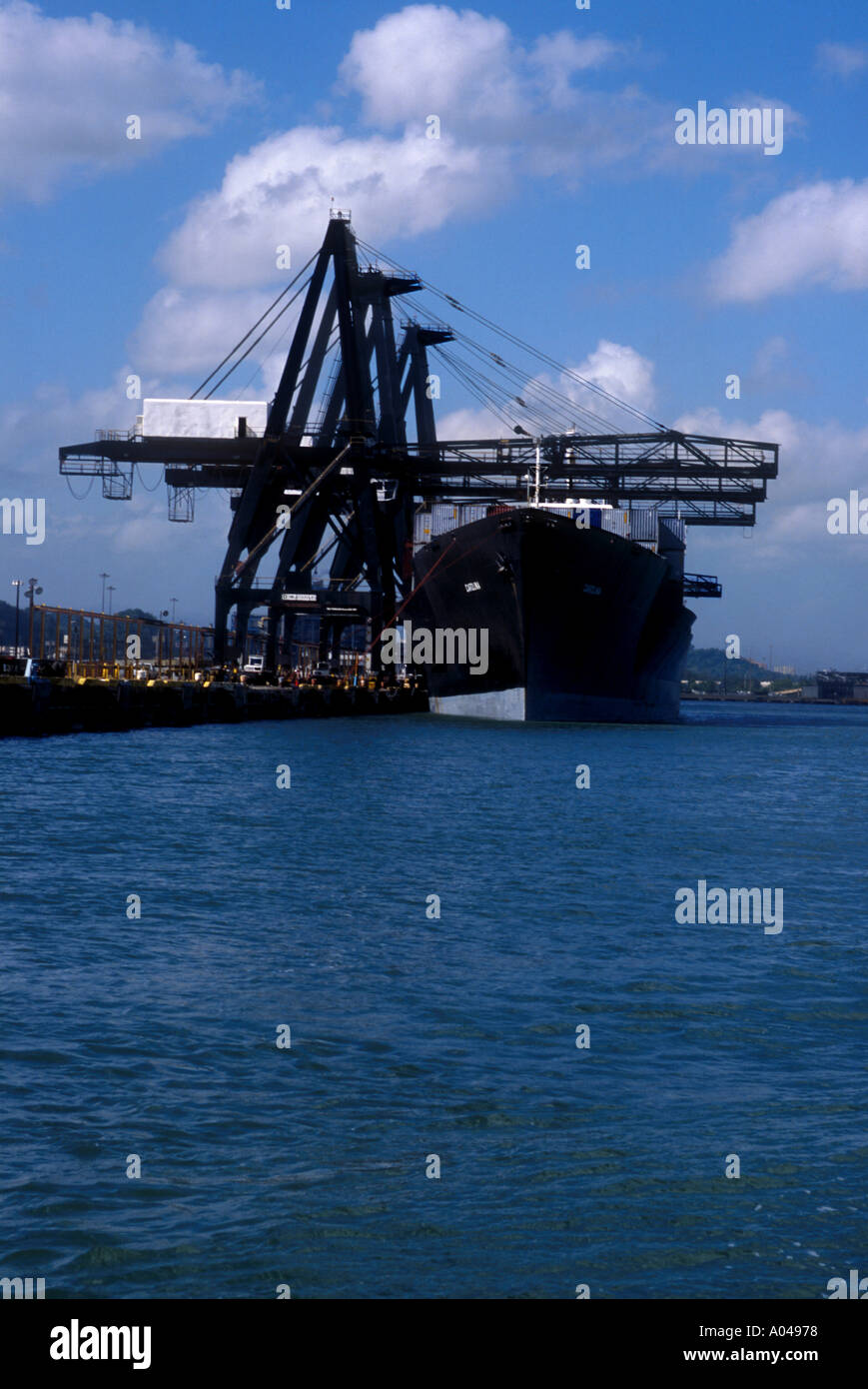 Containership at dock under loading crane Stock Photo - Alamy