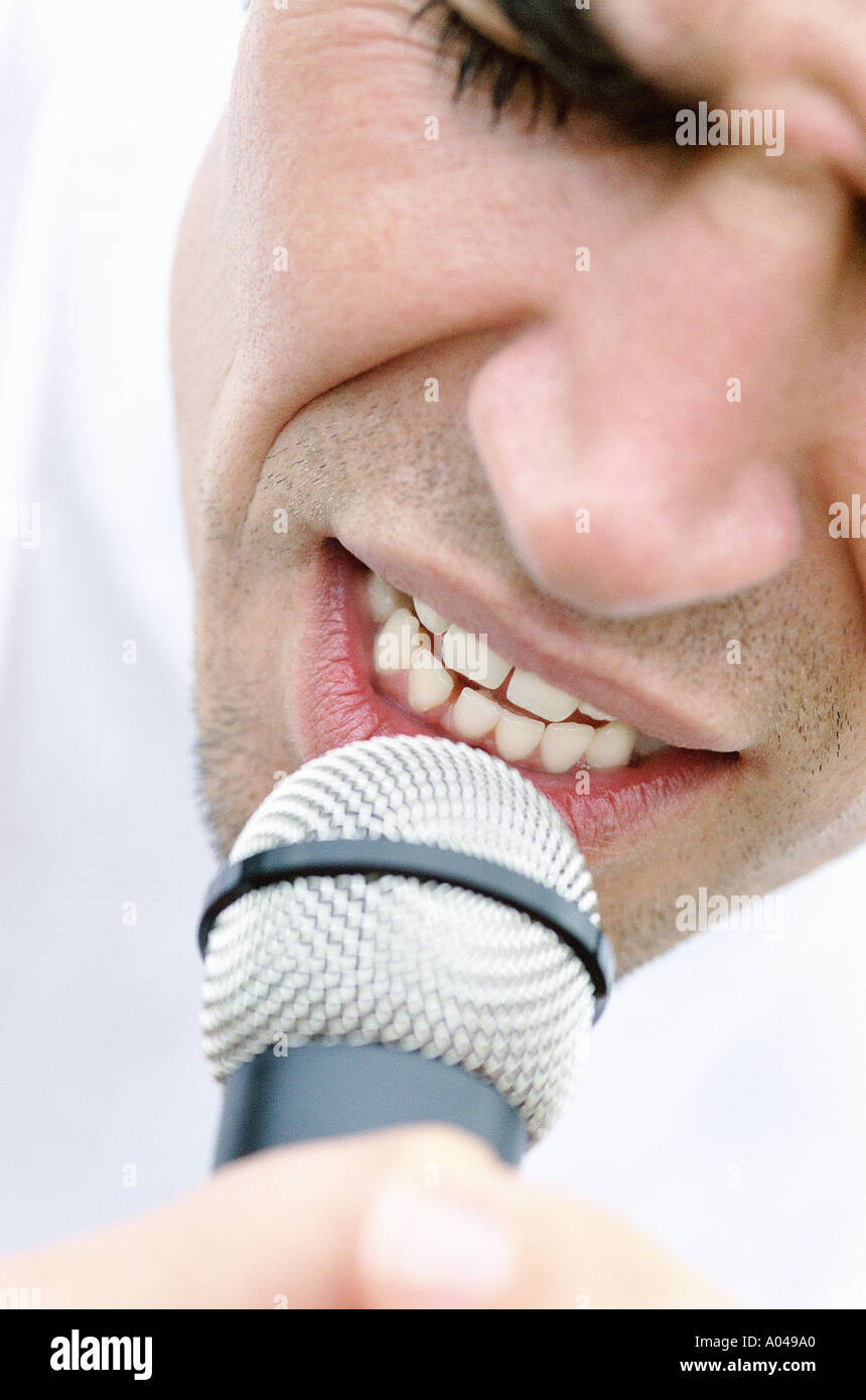 Man singing into microphone hi-res stock photography and images - Alamy