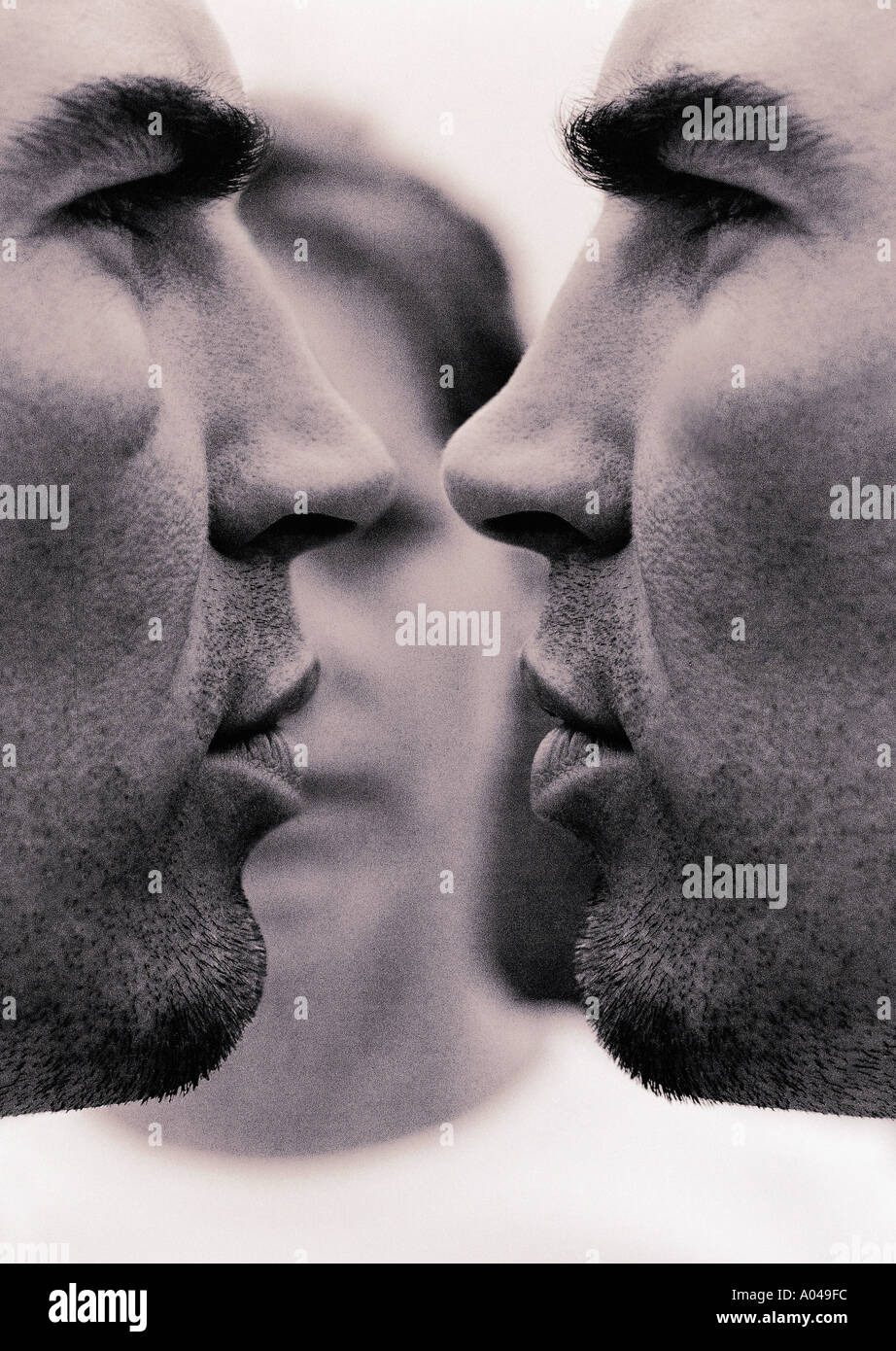 Portrait of two young men standing face to face with woman in the ...