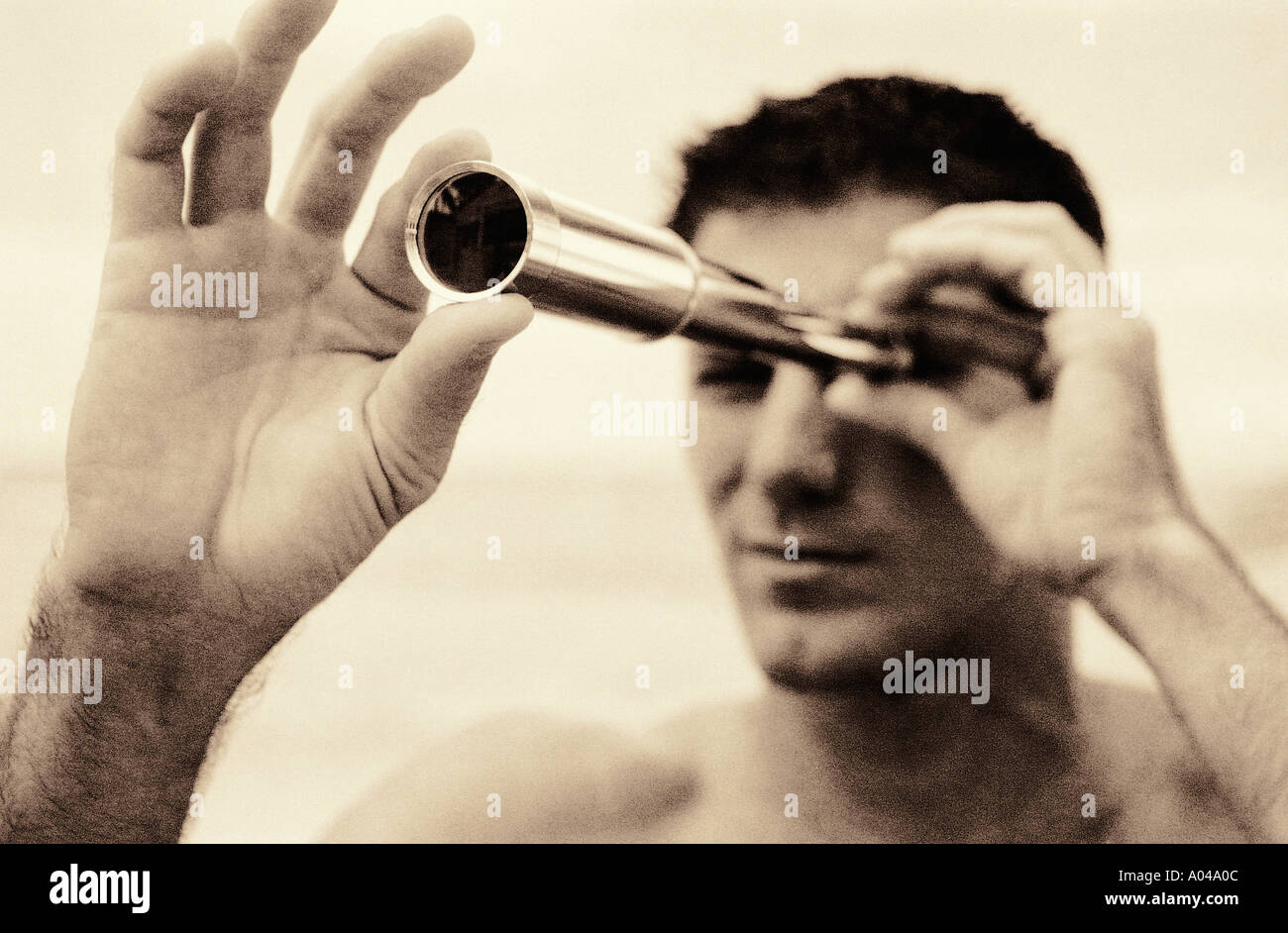 Portrait of a young man looking through a telescope Stock Photo - Alamy