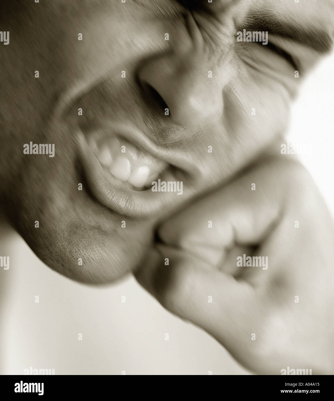 Close up portrait of a man's face being punched by a clenched fist ...