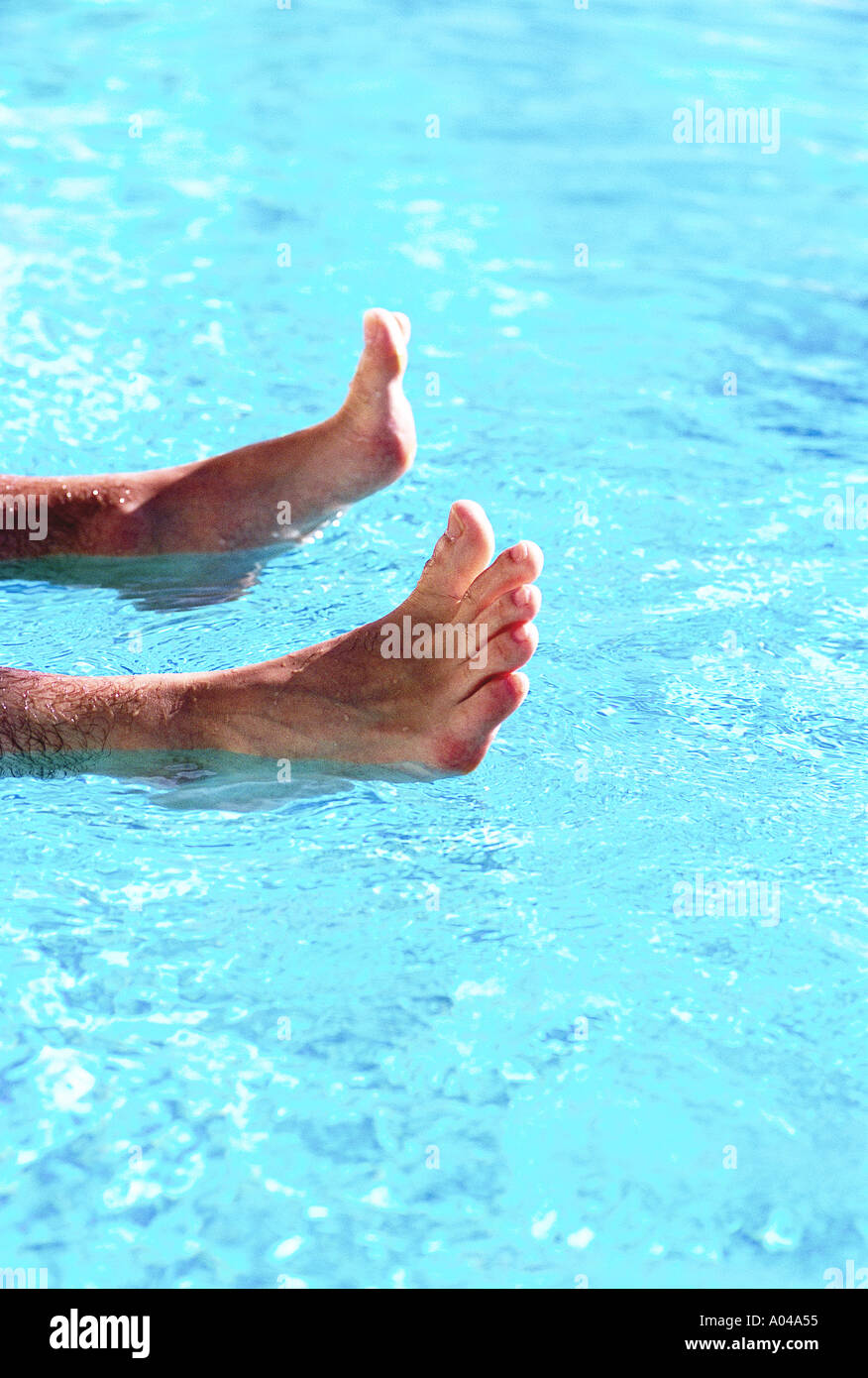 Close up of a man's feet floating in a blue pool Stock Photo - Alamy