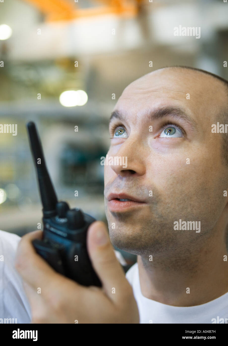 Factory worker using walkie talkie Stock Photo - Alamy