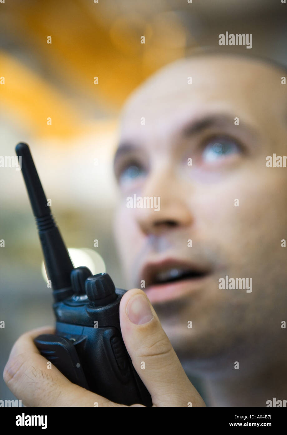 Factory worker using walkie talkie Stock Photo - Alamy