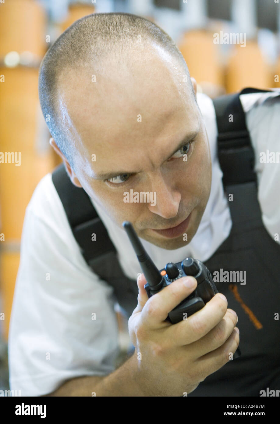 Factory worker using walkie talkie Stock Photo - Alamy