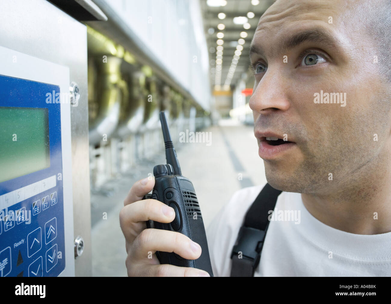 Factory worker using walkie talkie Stock Photo - Alamy
