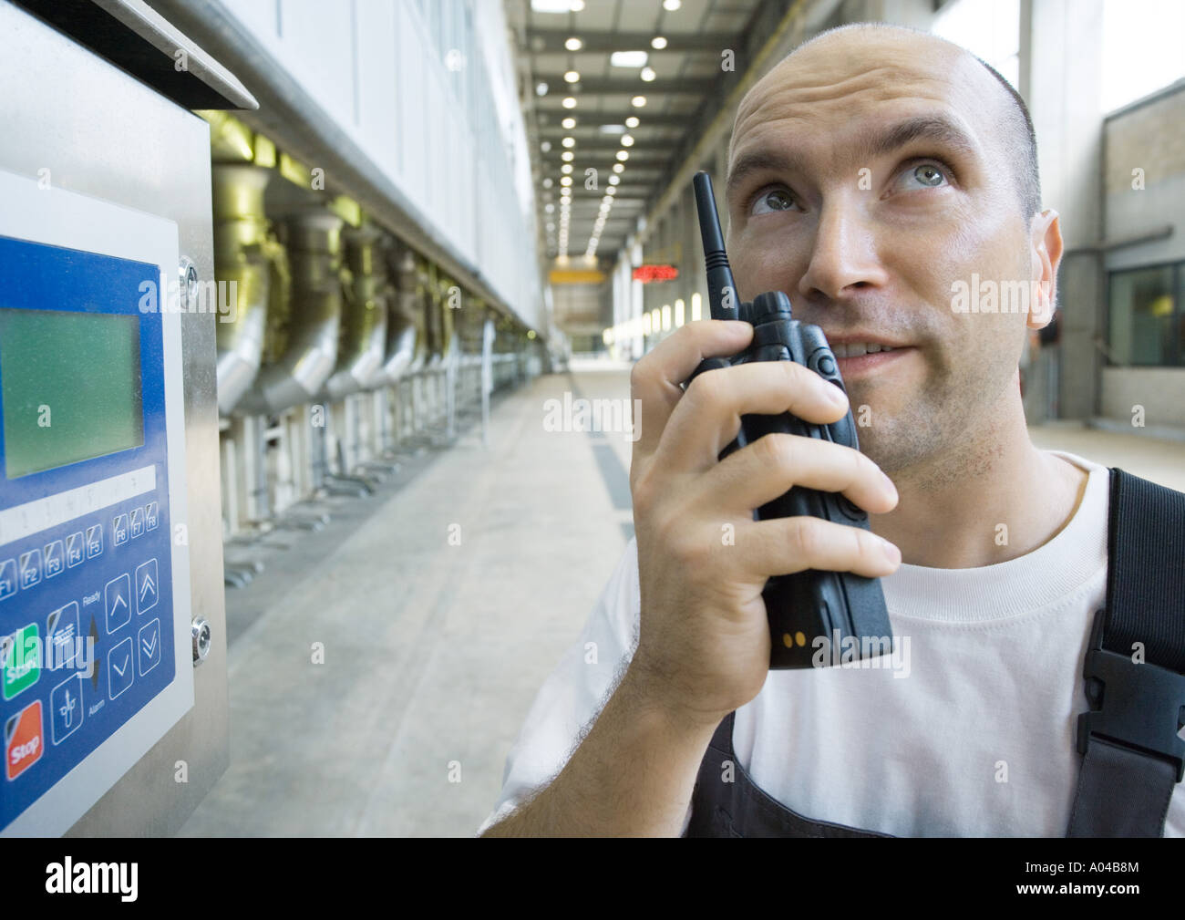 Factory worker using walkie talkie Stock Photo - Alamy