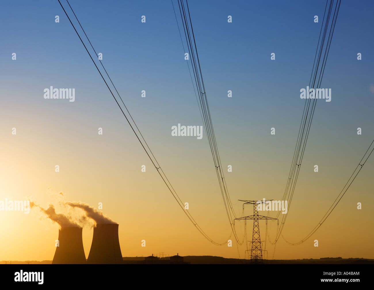 Nuclear cooling towers and electric wires and pylon at sunset Stock ...