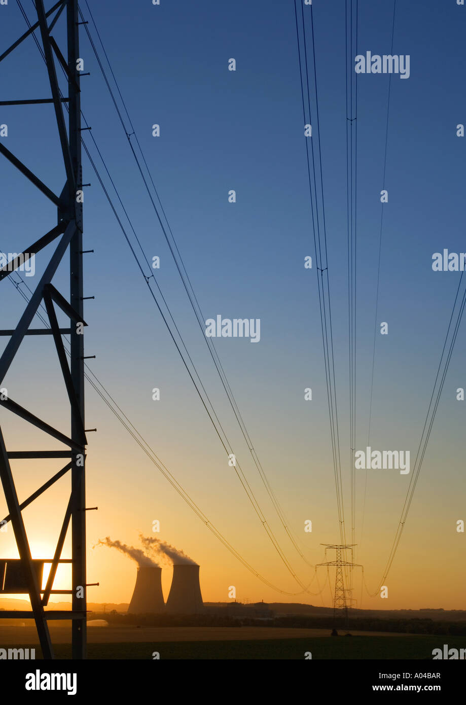 Nuclear cooling towers and electric wires and pylon at sunset Stock ...