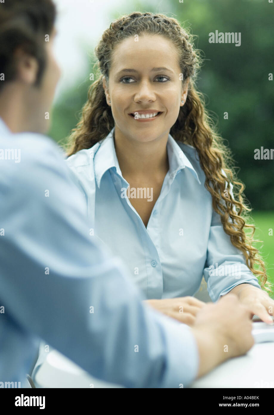 Woman smiling at man Stock Photo - Alamy