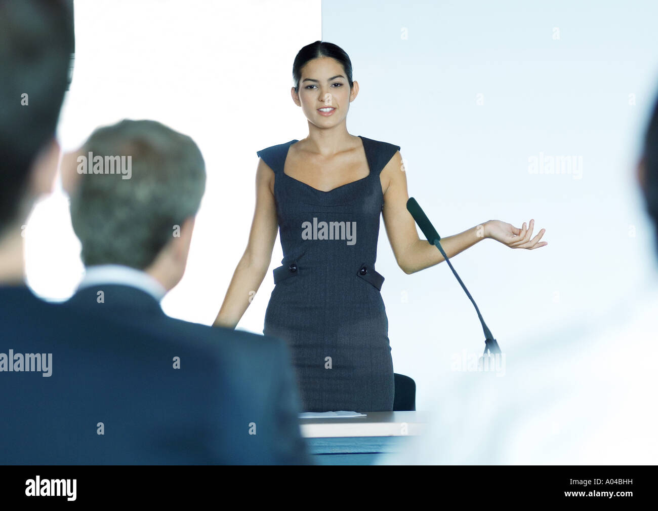 Businesswoman speaking with microphone during seminar Stock Photo - Alamy