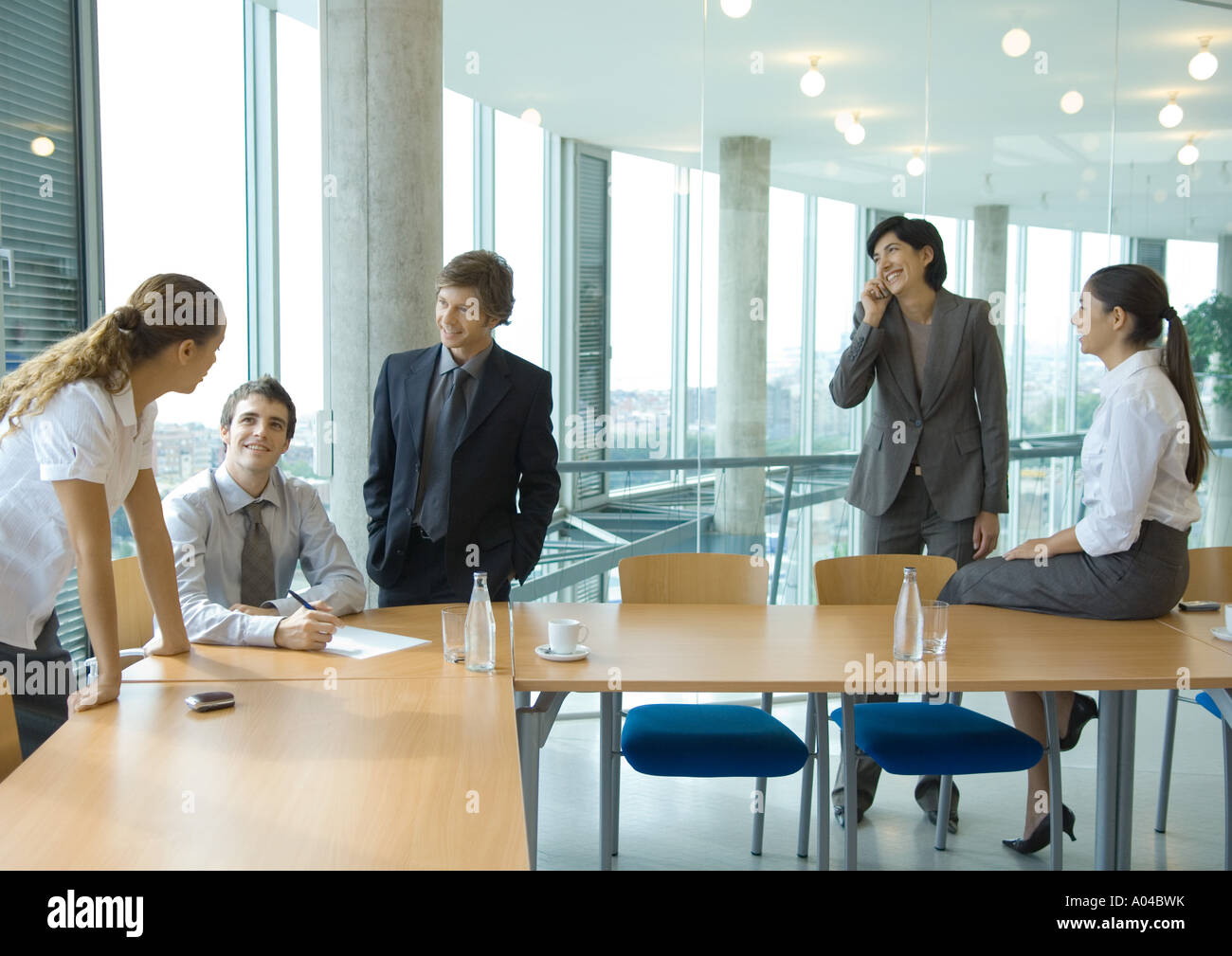 Business colleagues standing, discussing Stock Photo - Alamy