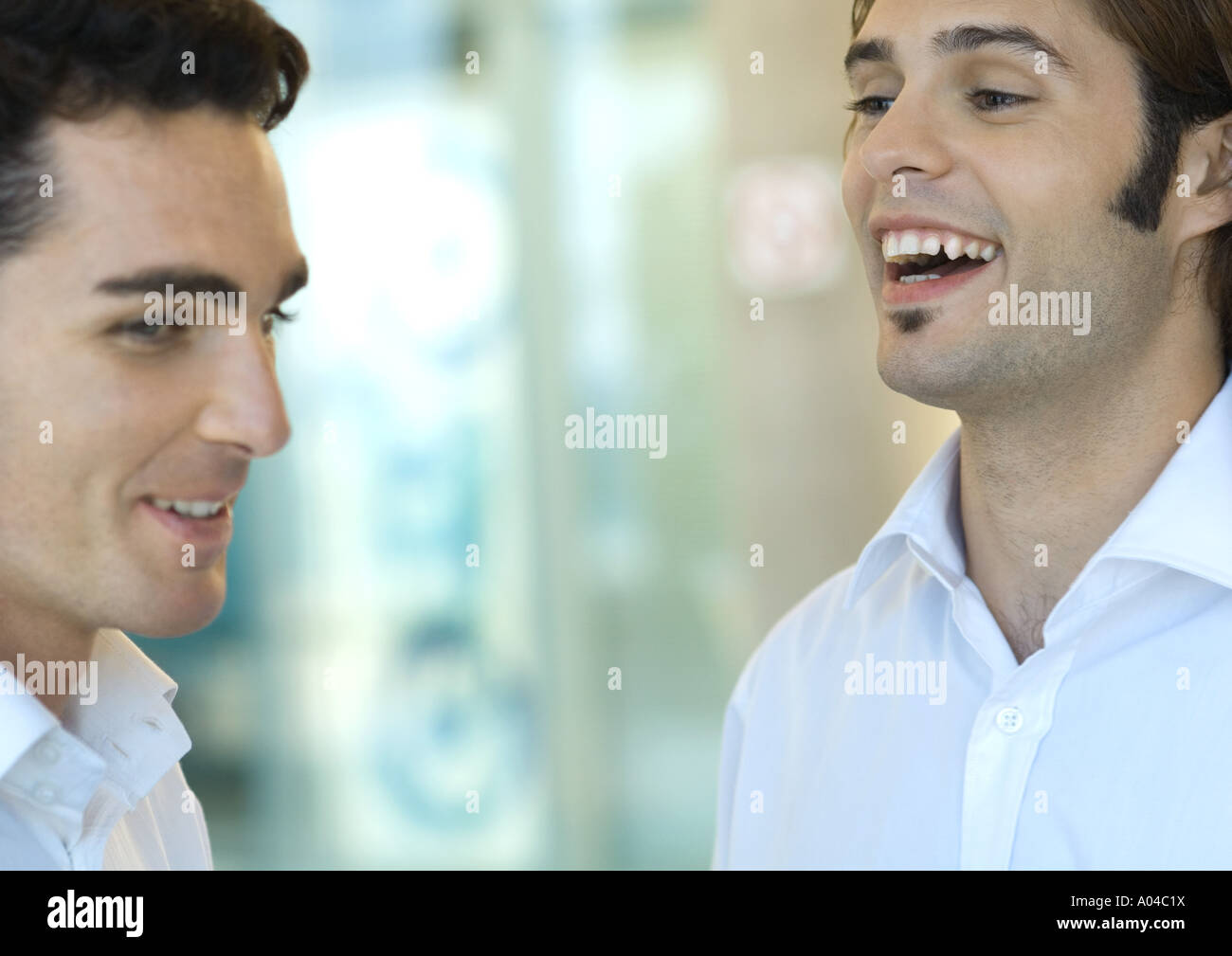 Two young male executives laughing Stock Photo - Alamy