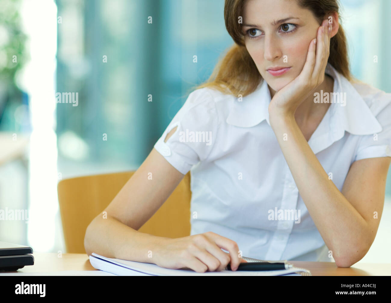 Female office worker sitting at desk Stock Photo - Alamy
