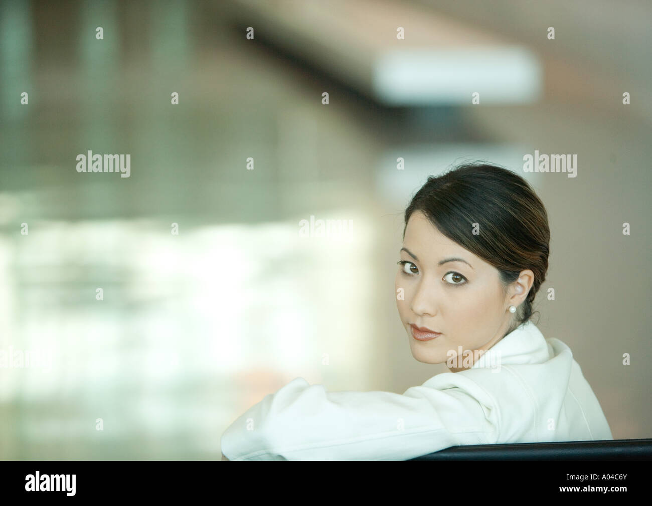 Woman, looking over shoulder at camera Stock Photo - Alamy
